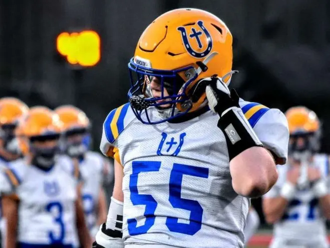 Sandfoss serves as a coach on the field for NewCath